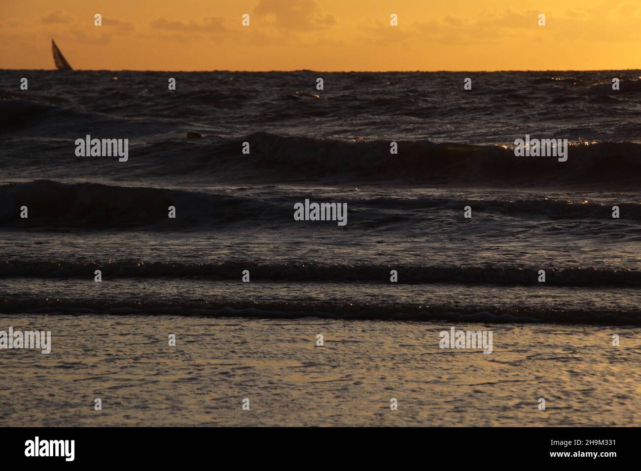The pattern of waves in the sea during the sunset on the beach. Golden ...