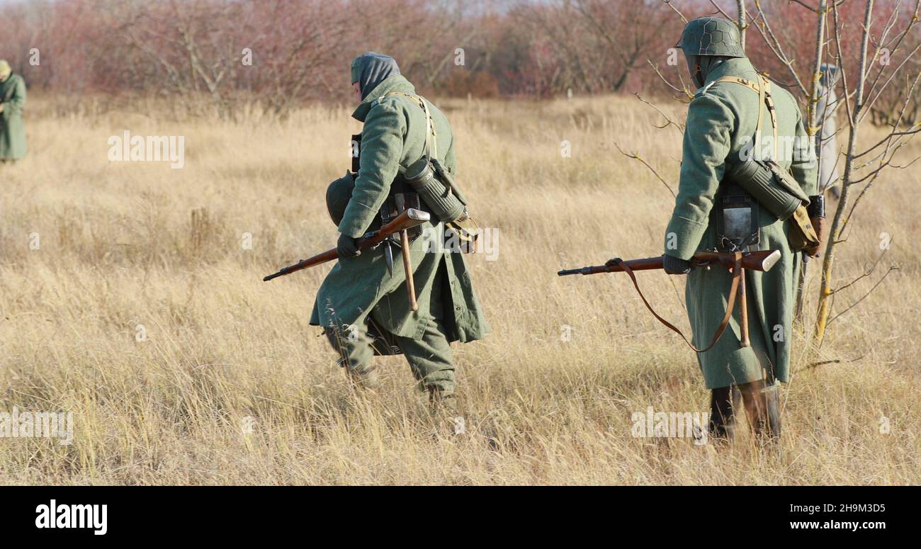 , German Wehrmacht Infantry Soldiers In World War II Walking In Patrol ...