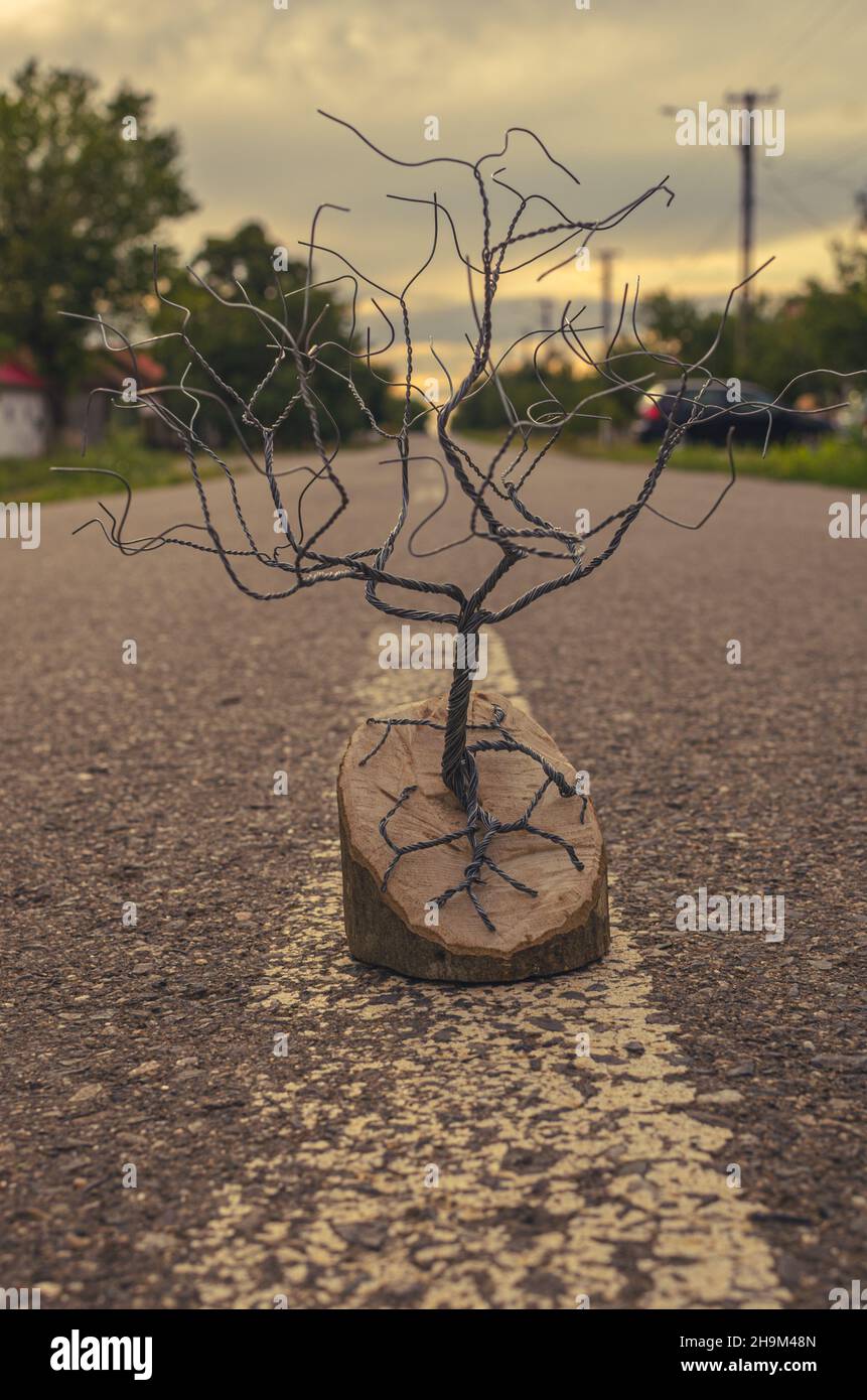 Vertical shot of a tree made of wire attached to a timber Stock Photo ...