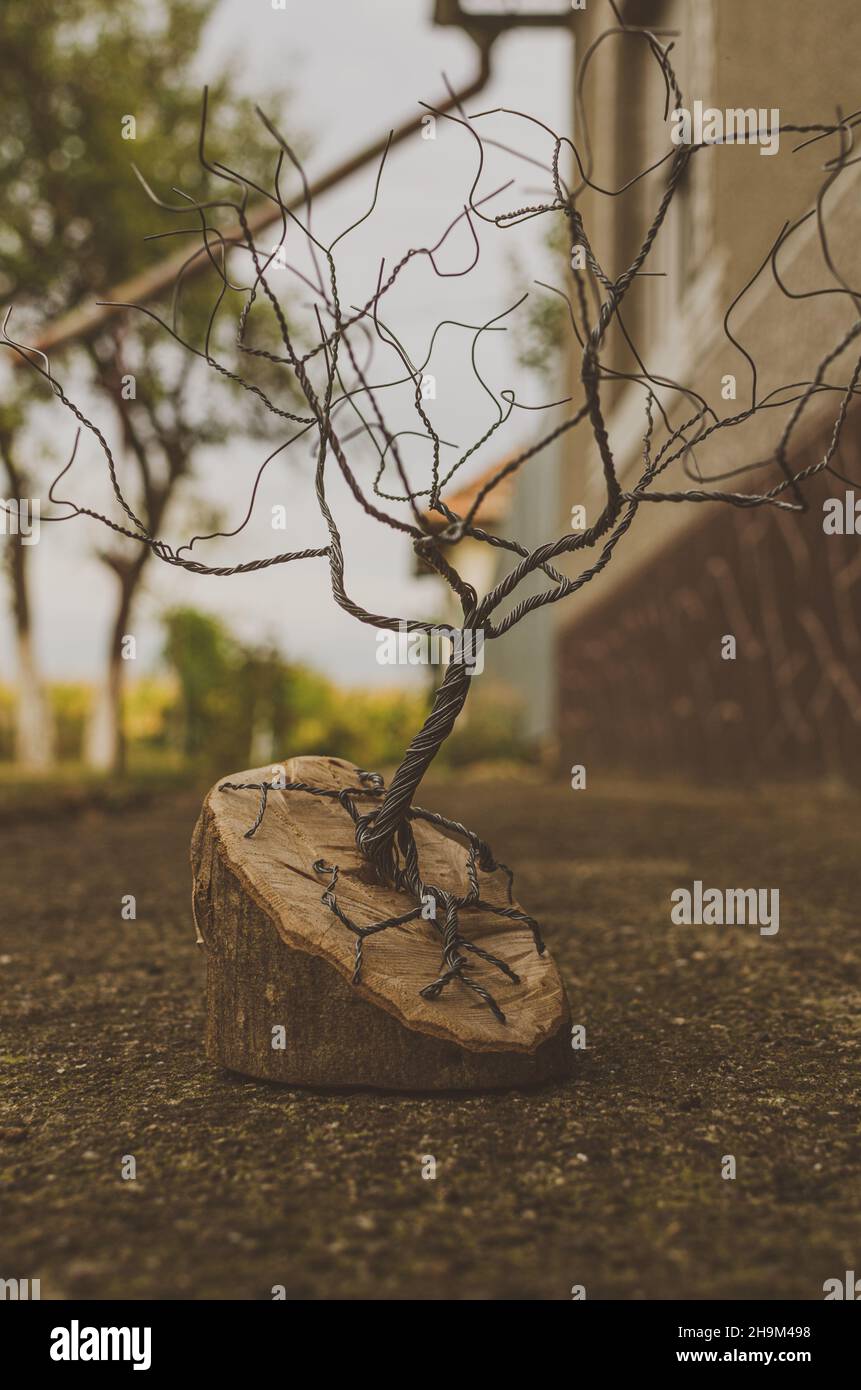 Vertical shot of a tree made of wire attached to a timber Stock Photo ...