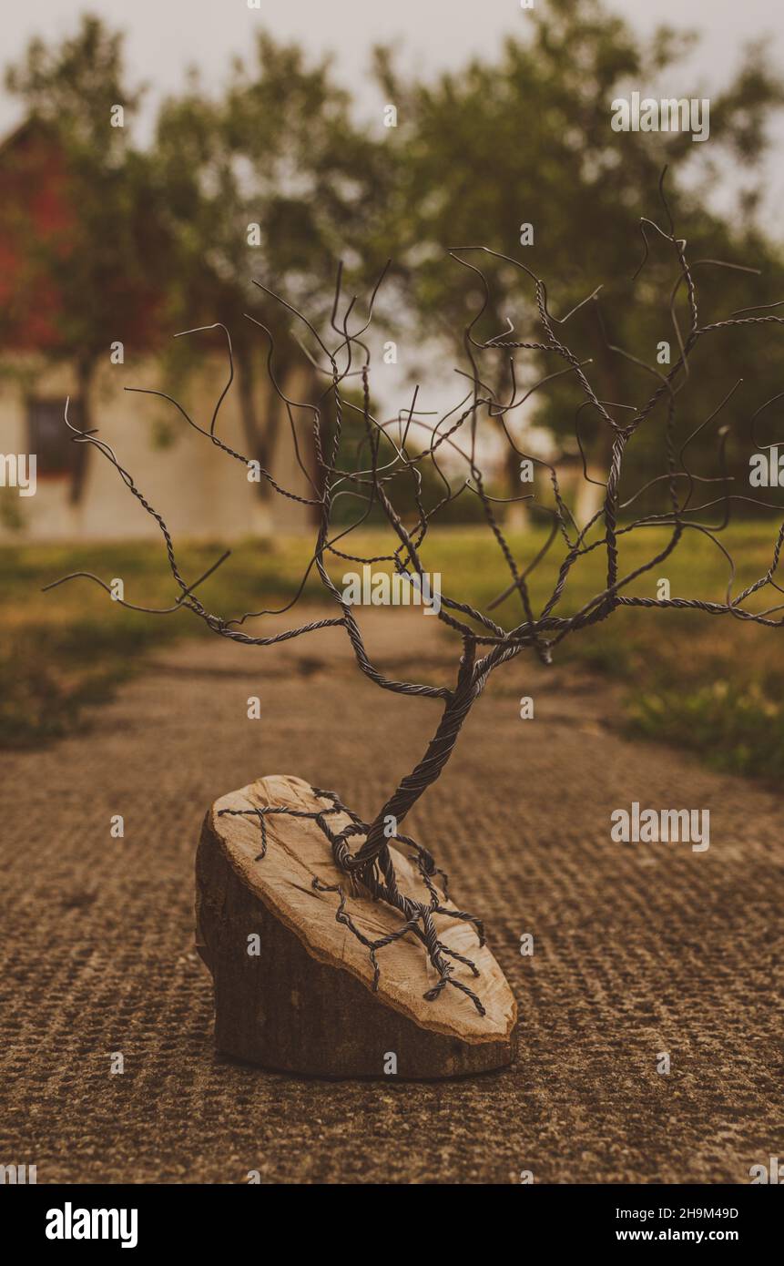 Vertical shot of a tree made of wire attached to a timber Stock Photo ...