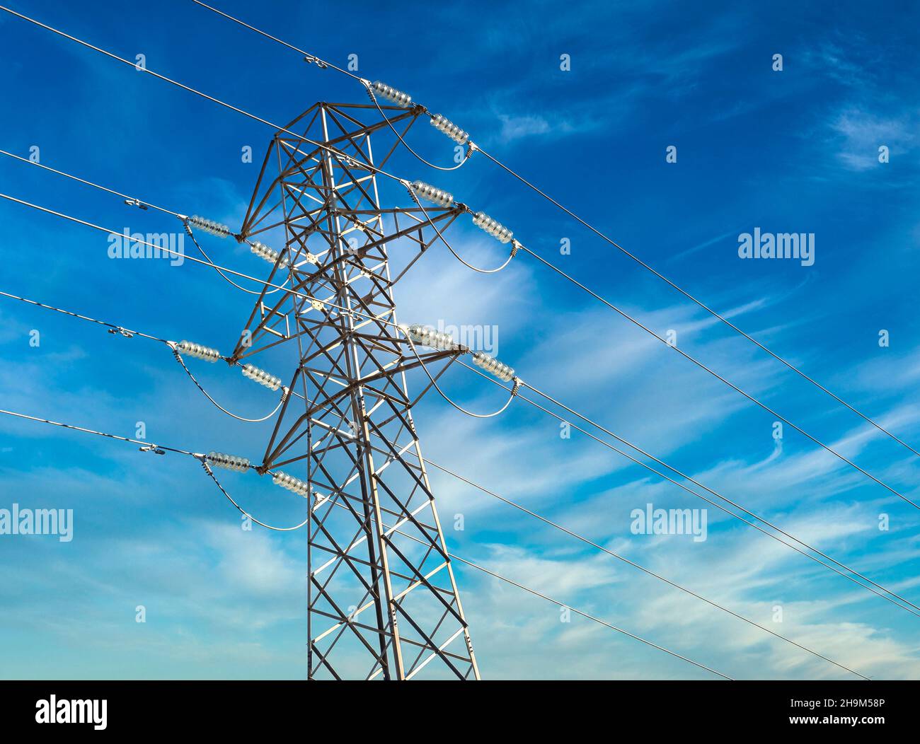 Power line, high voltage power line pylon. Cloudy sky background ...