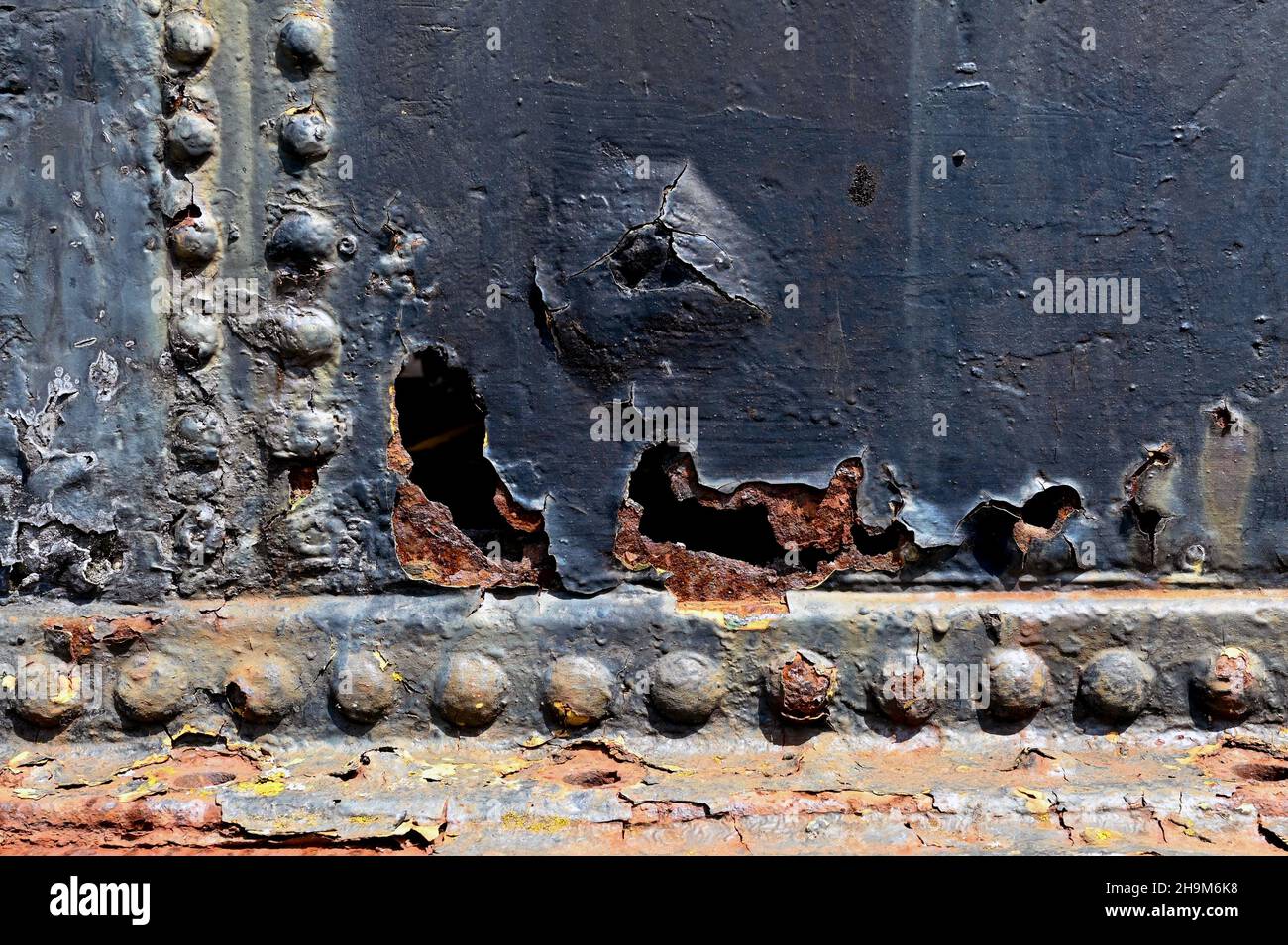 Close up of rusted metal plates on a stno people,eam engine. No people ...