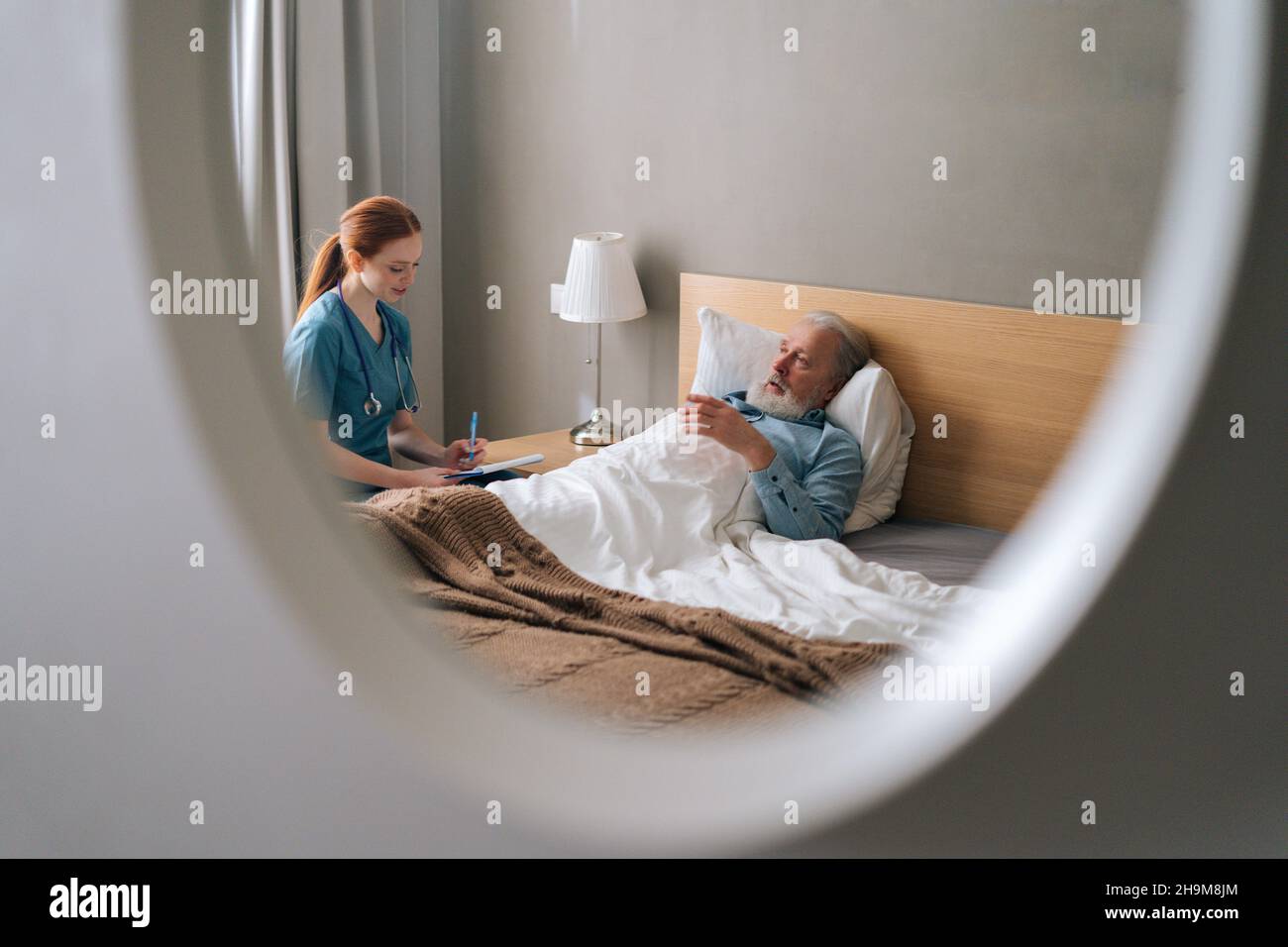 Reflection on mirror of female doctor writing down diagnosis and ...