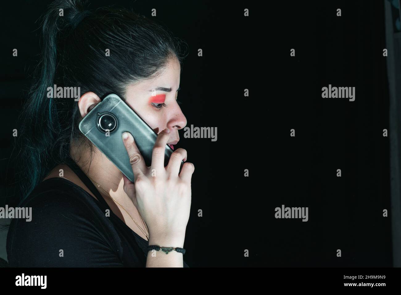 Beautiful Latina Woman With Green Hair Receiving A Call With Her Cell