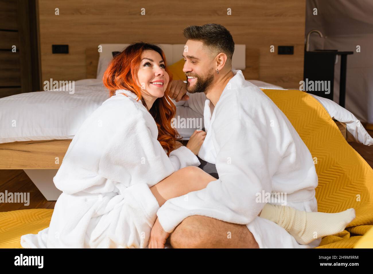 Attractive couple cuddling on bed hi-res stock photography and images ...