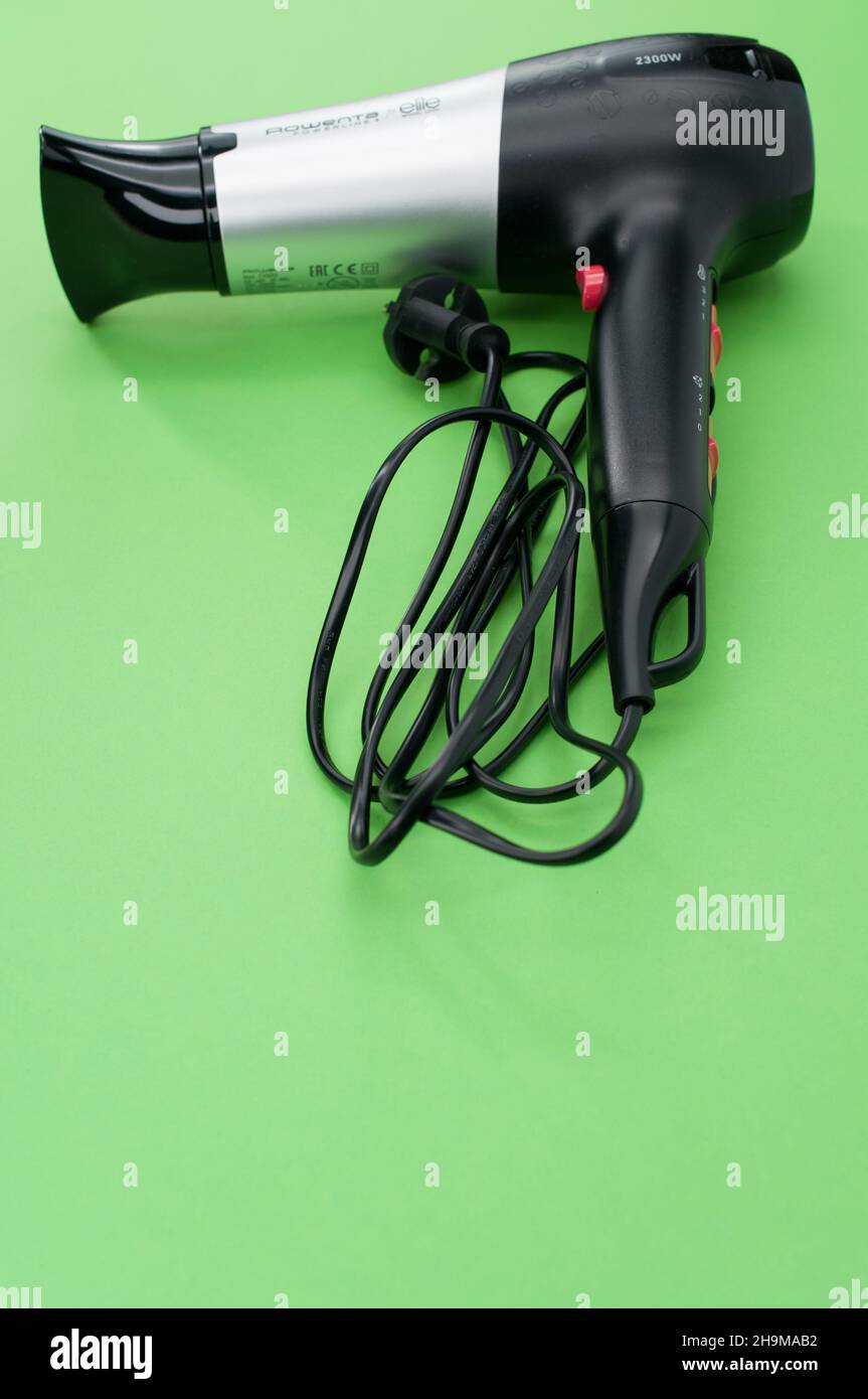 INVERIGO, ITALY - Dec 07, 2021: isolated hair dryer on a green background with text space Stock ...