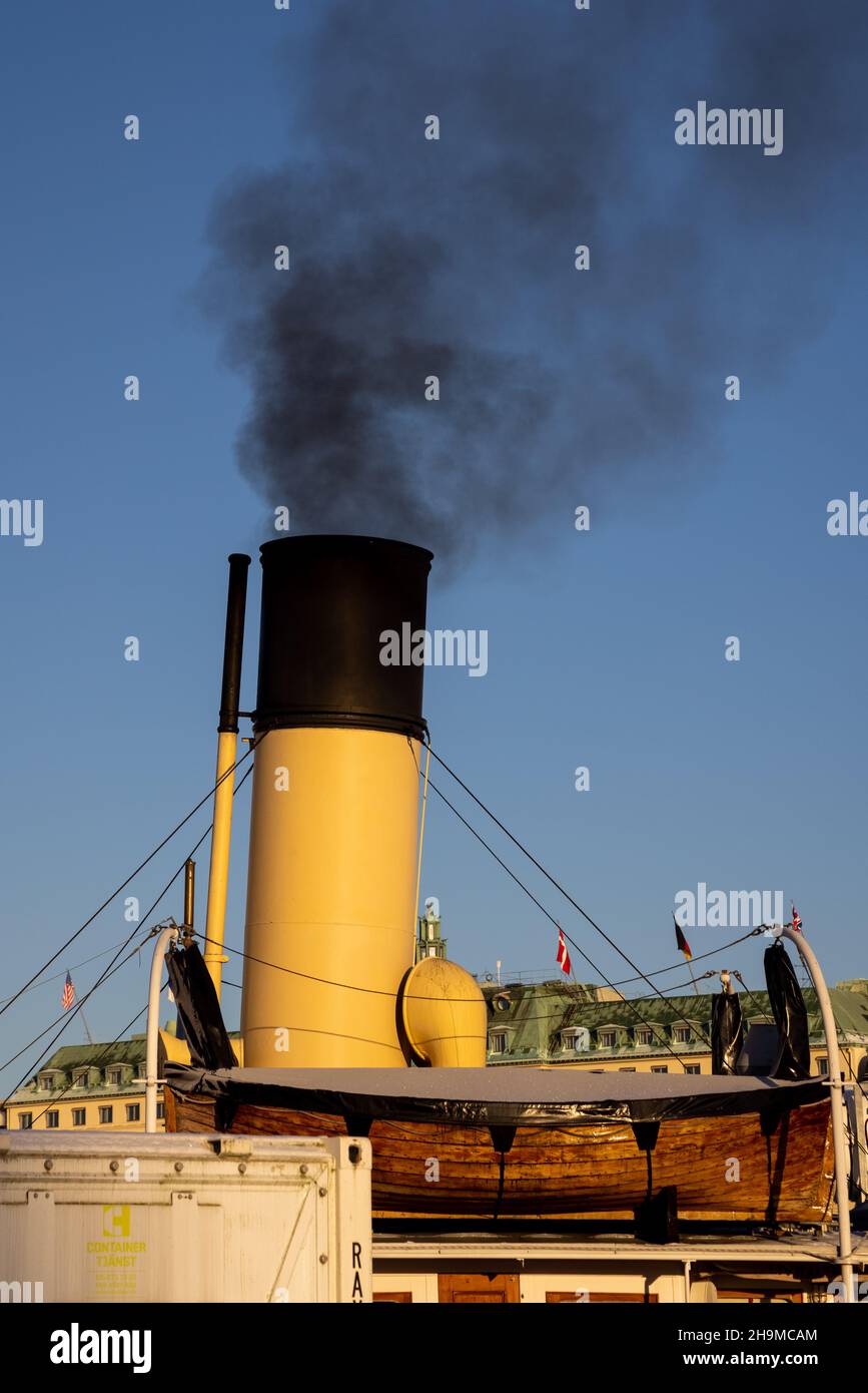 Air pollution in Stockholm. Chimney of boat with black smoke coming out ...