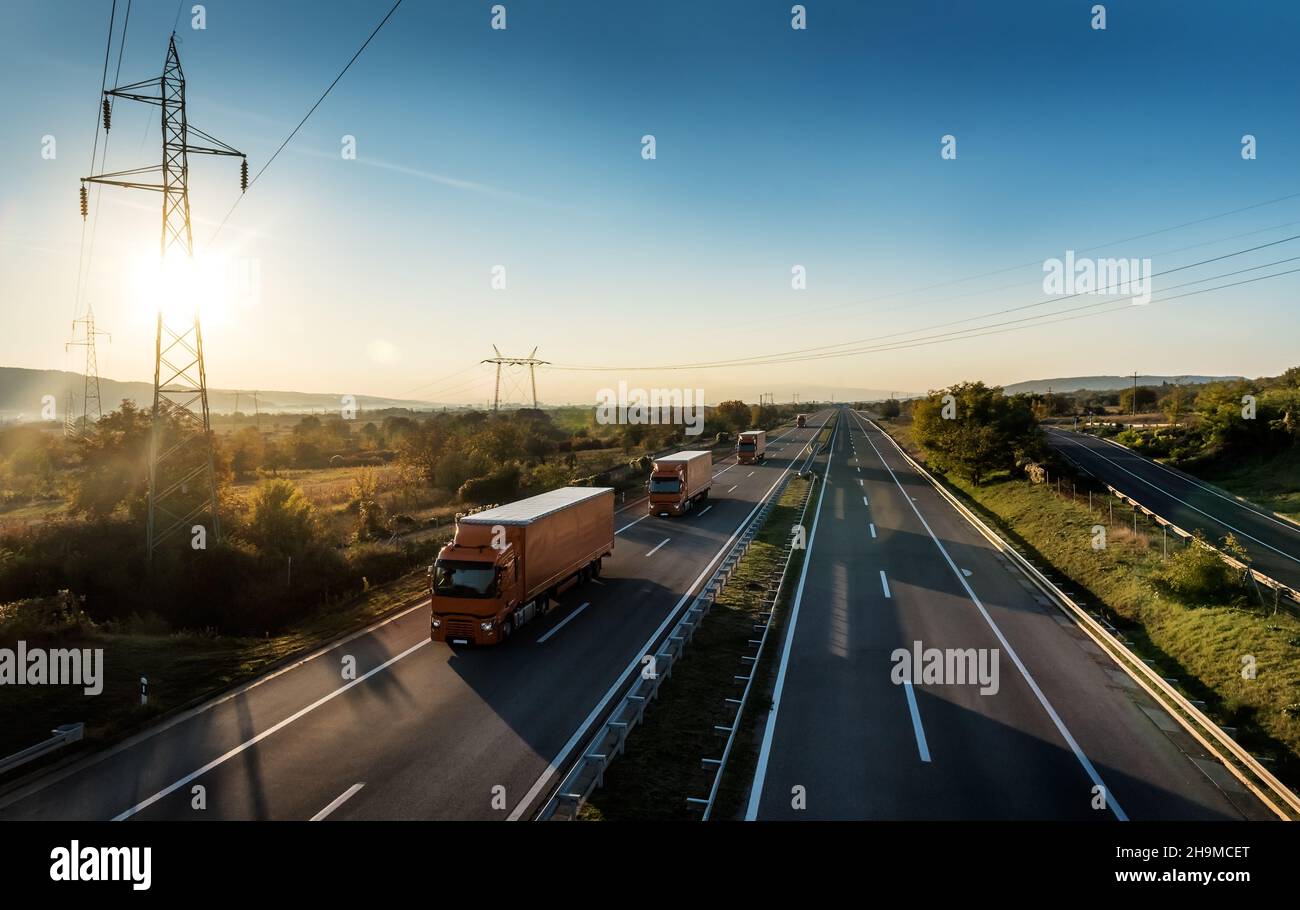 Sunset Highway transit. Convoy or caravan of Orange transportation ...