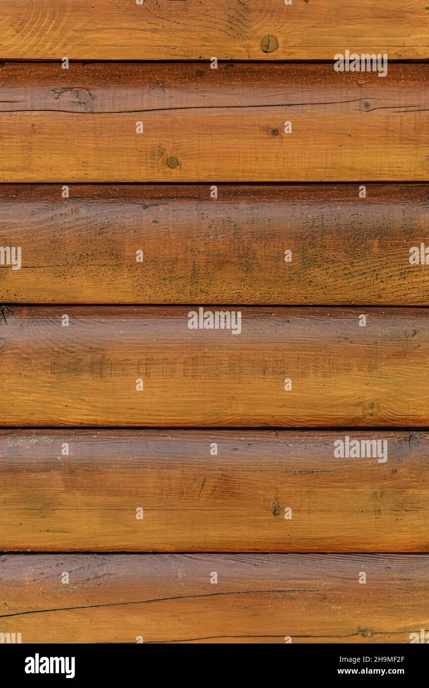 Log background. Rough wood texture. The walls of a country house are ...