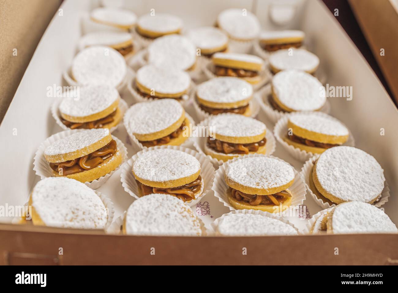 Box with a group of candy individual pastries ready to be sold in a ...