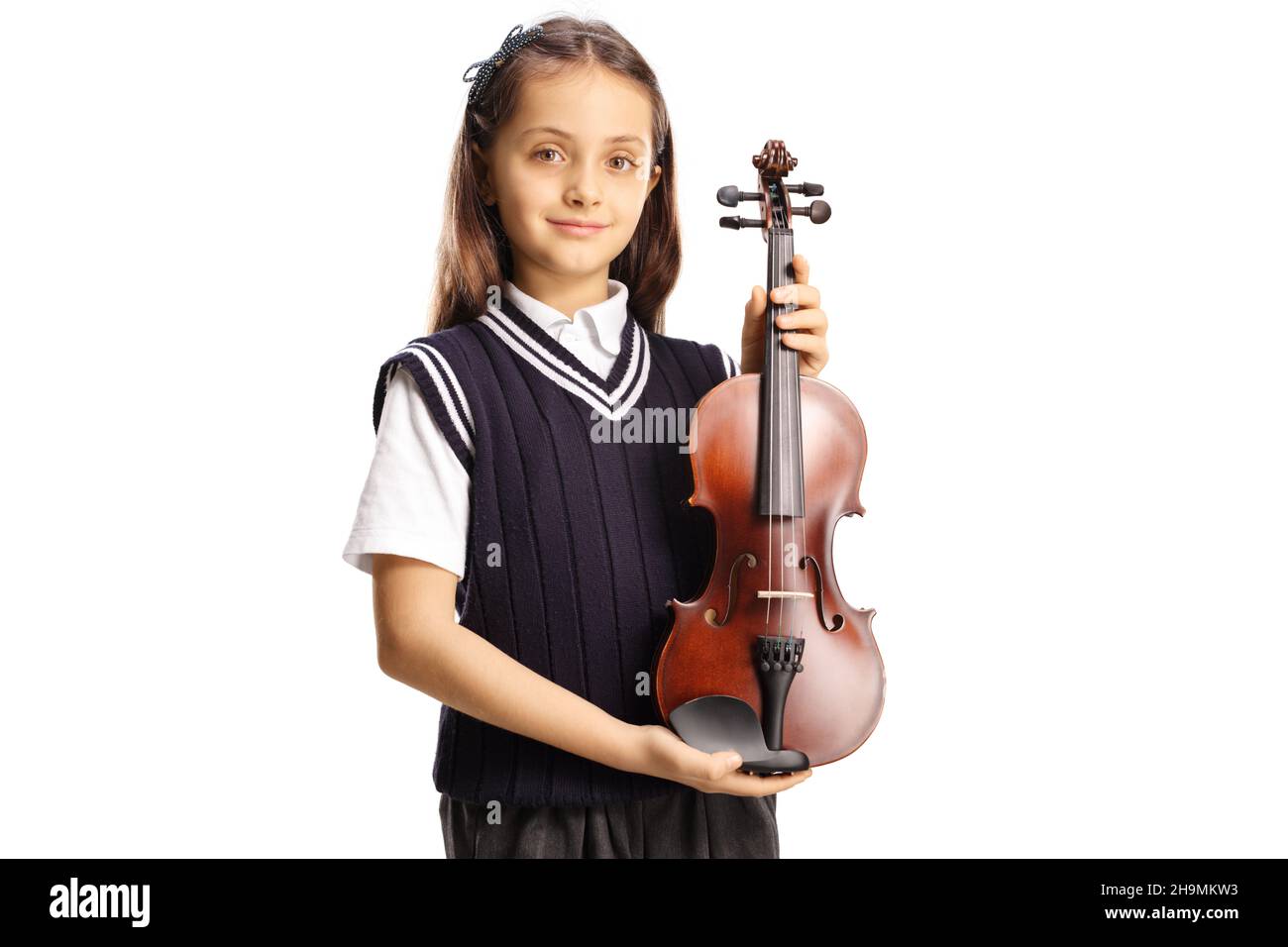 Girl in a school uniform holding a violin isolated on white background ...