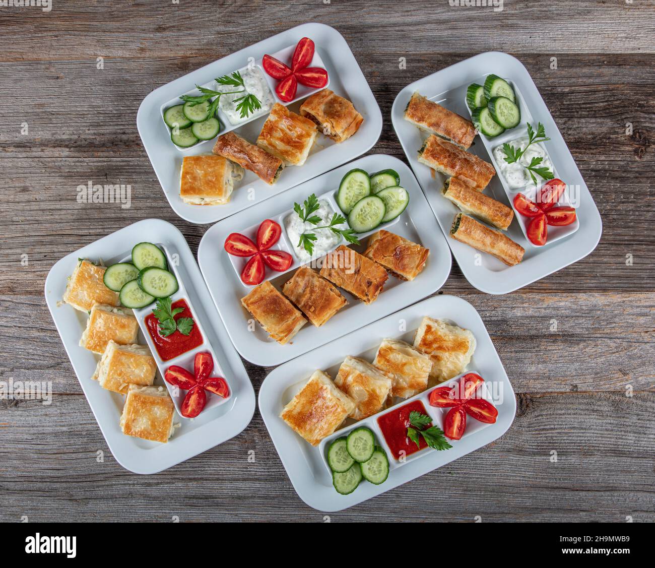 Borek varieties on the Turkish cuisine serving plates on the wooden ...