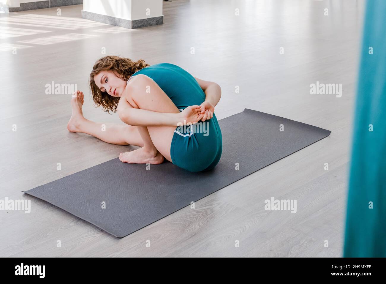 Young woman doing stretch pose to support the back muscles. practice of ...