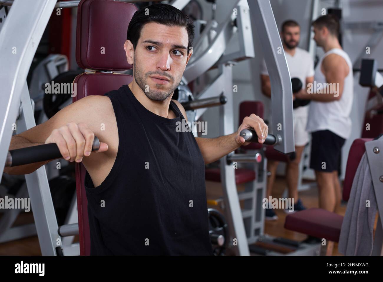 Triceps workout on machine young hi-res stock photography and images ...