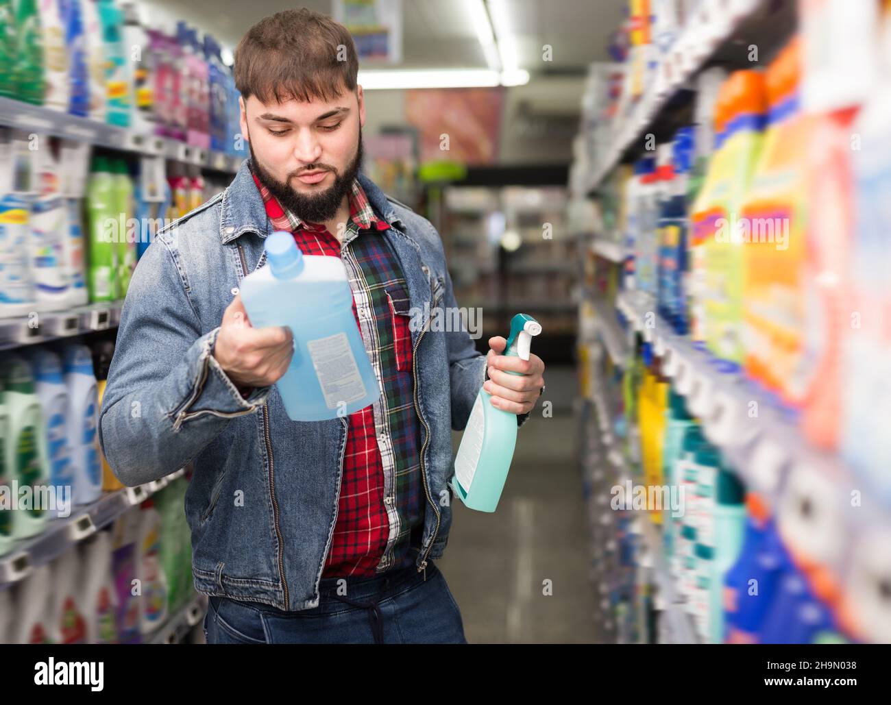 Serious young customer choosing goods hi-res stock photography and ...