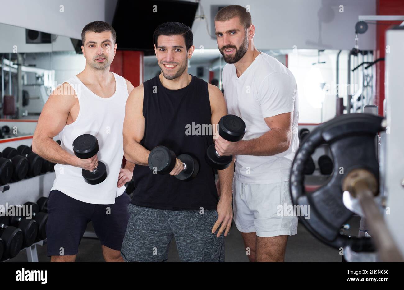 Three men in gym Stock Photo - Alamy