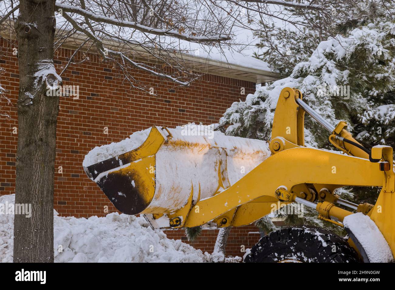 Tractor removing snow on street after snowfall Stock Photo - Alamy