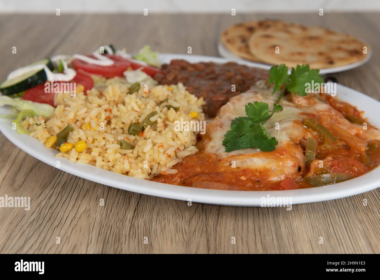 Generous serving of chile relleno aloong with refried beans, rice, and ...