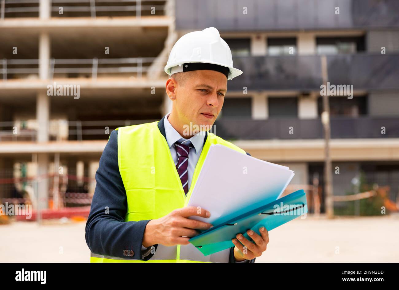 Civil engineer carefully studies work documents Stock Photo - Alamy