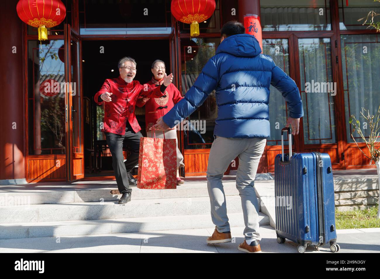 Cheerful man greeting parents hi-res stock photography and images - Alamy