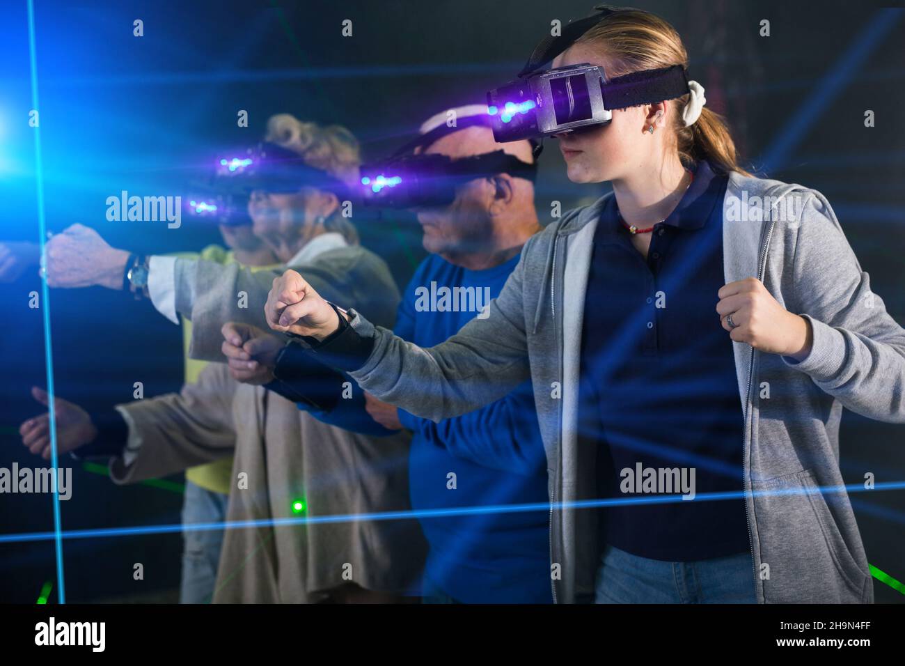 Girl in VR headset playing games with his family Stock Photo - Alamy