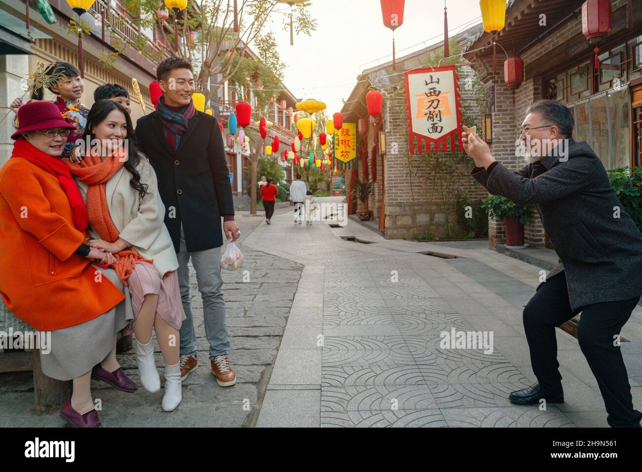 Temple fairs to pose for photos of family of six Stock Photo - Alamy