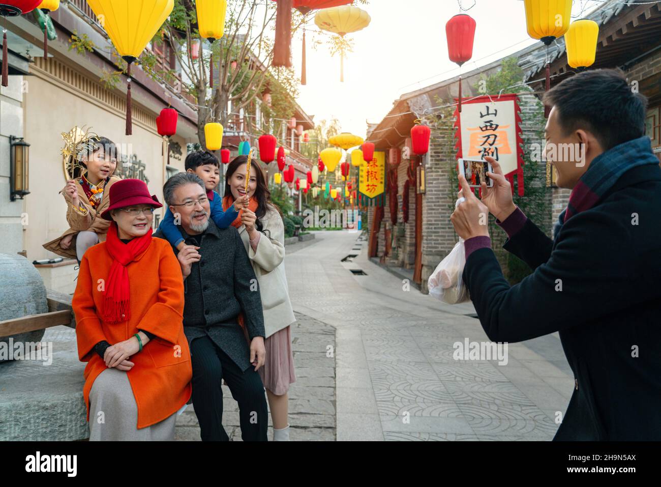 Temple fairs to pose for photos of family of six Stock Photo - Alamy