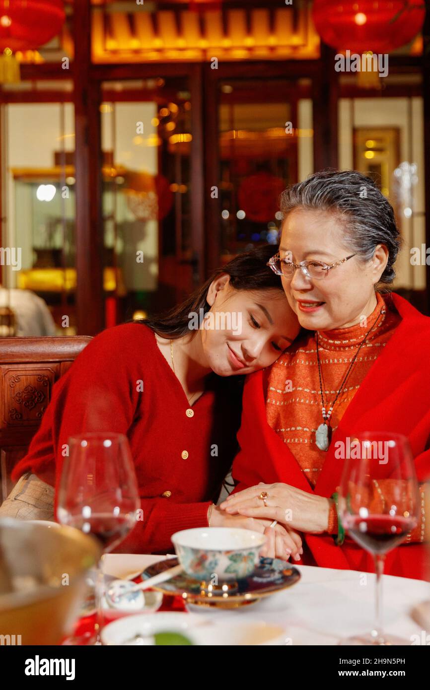 Happy mother and daughter snuggled up together Stock Photo - Alamy
