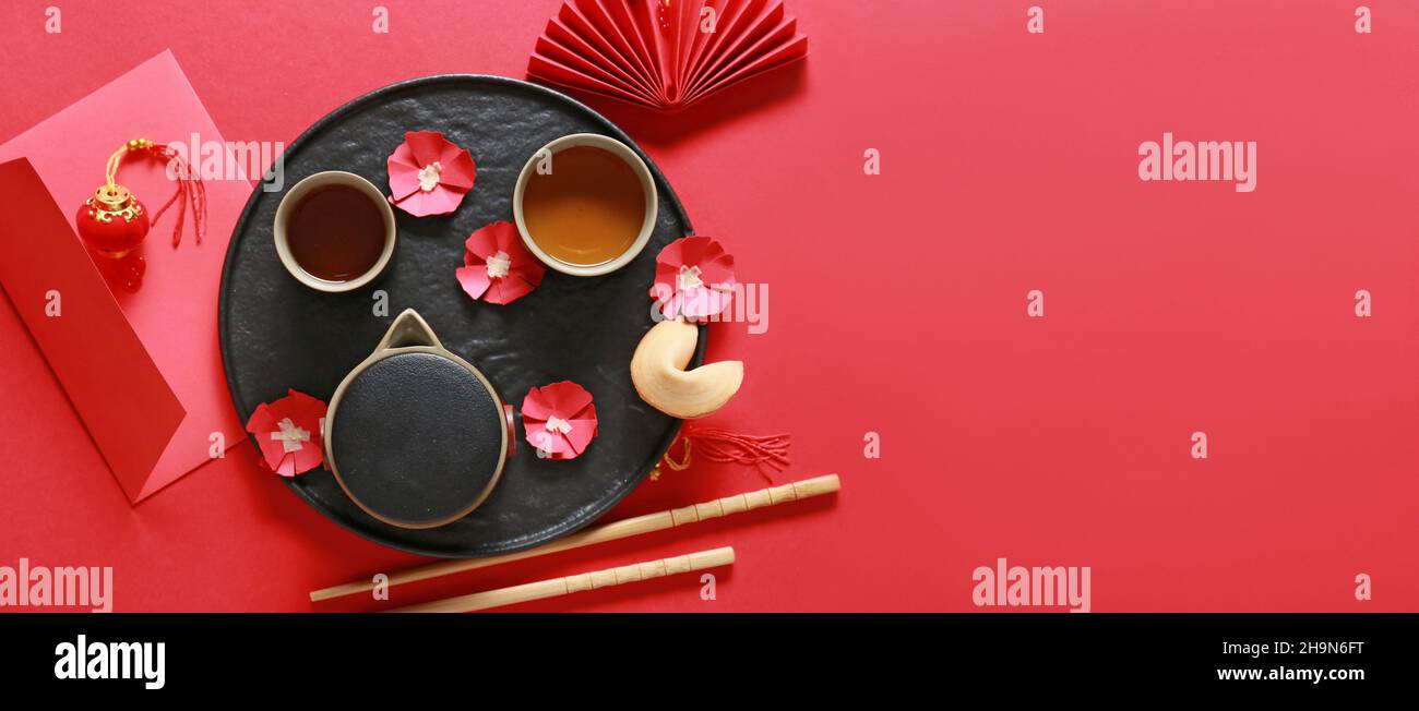 Traditional Chinese tea with envelope on red background with space for ...