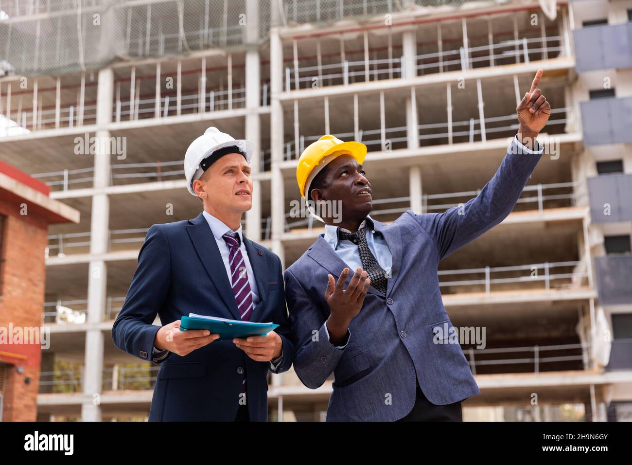 Two engineers discussing new construction Stock Photo - Alamy