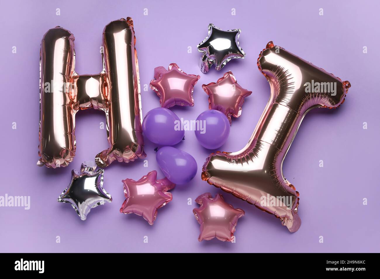 Word HI made of balloons on purple background Stock Photo - Alamy
