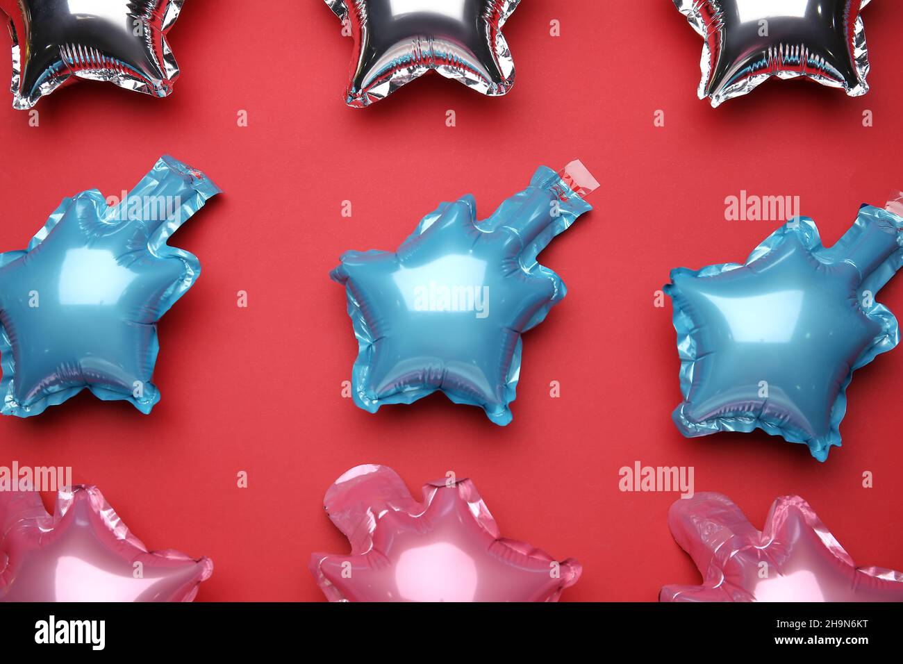 Beautiful different balloons on red background Stock Photo - Alamy
