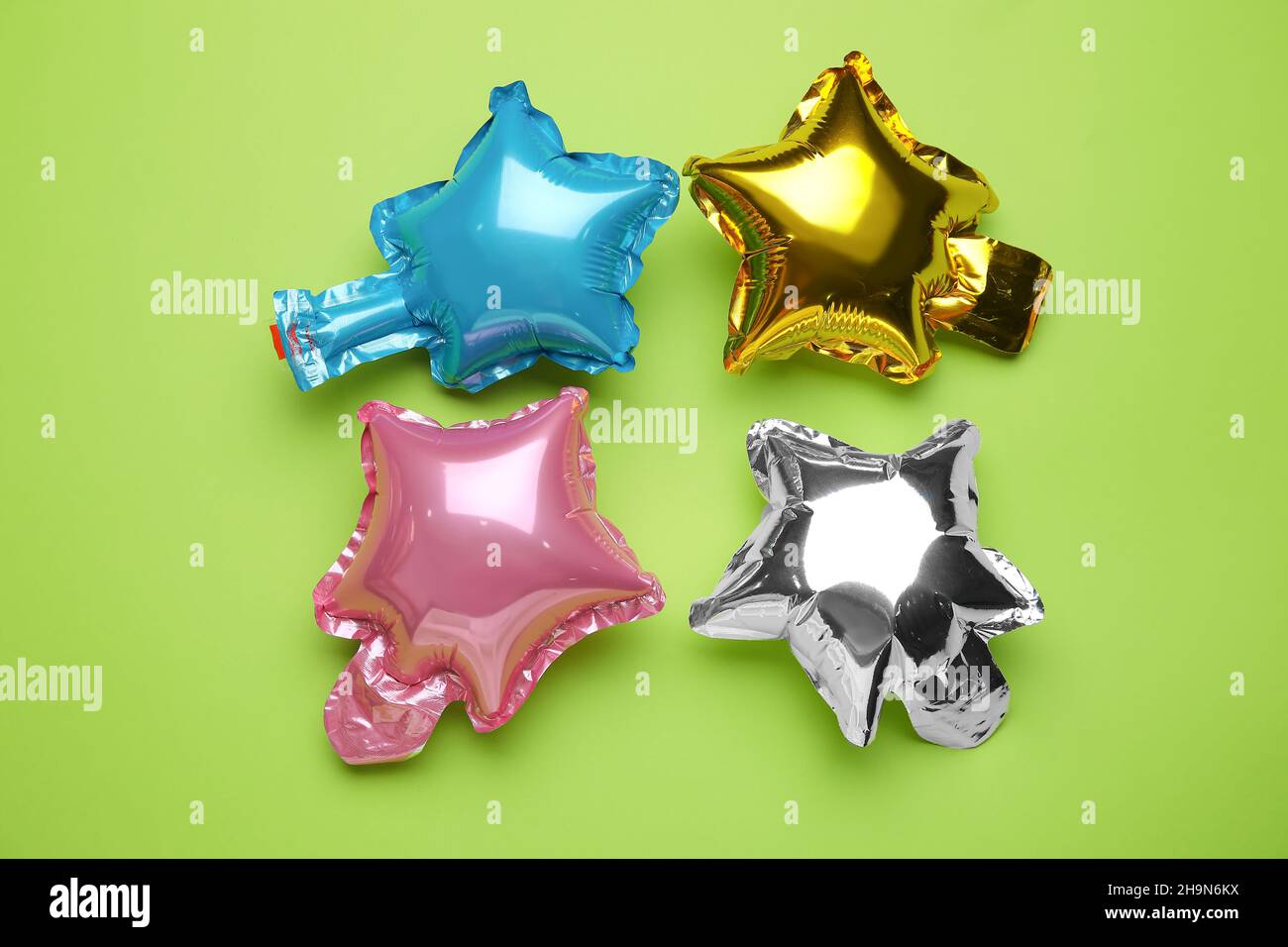 Beautiful different balloons on green background Stock Photo - Alamy
