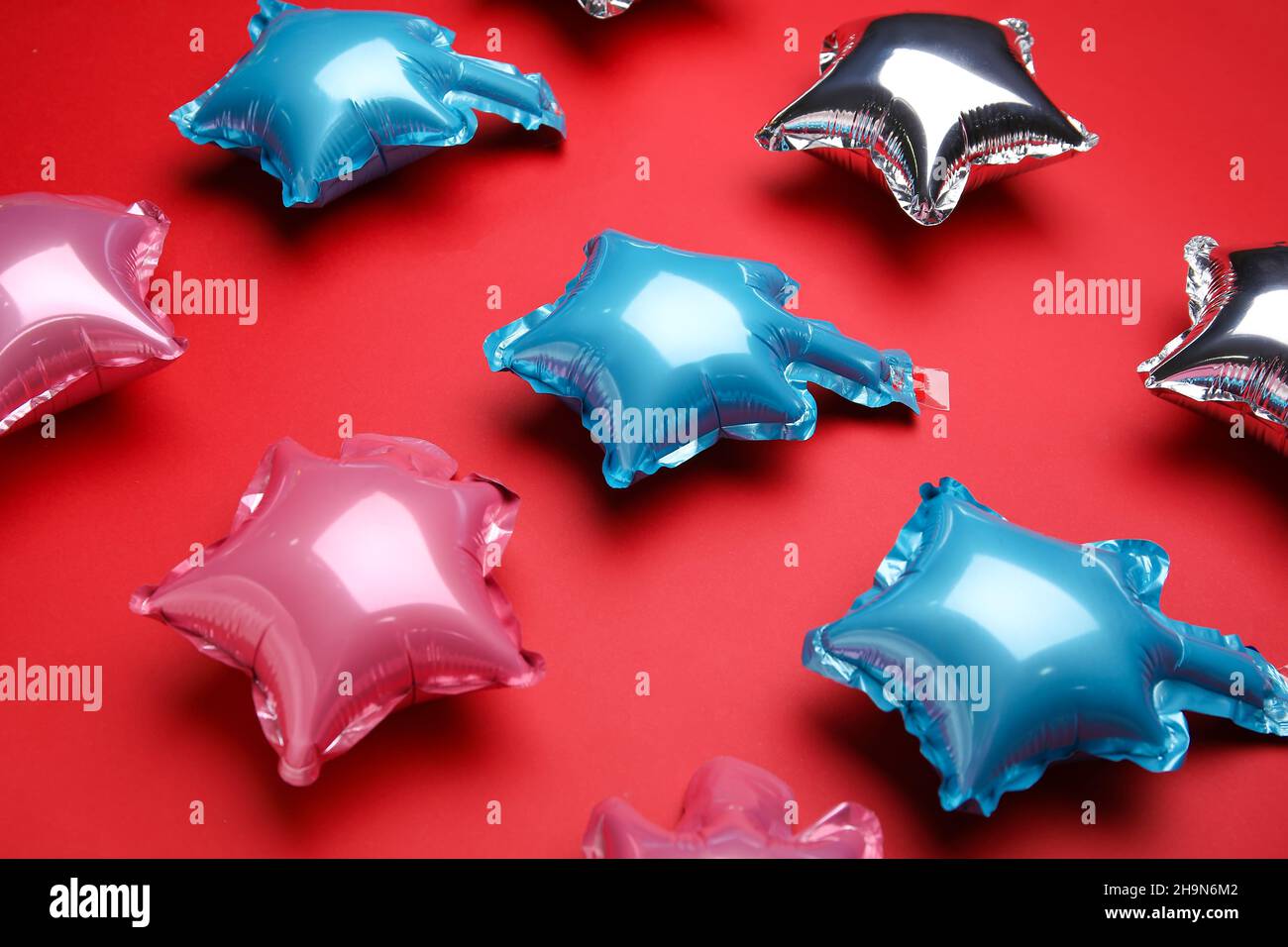 Beautiful different balloons on red background Stock Photo - Alamy