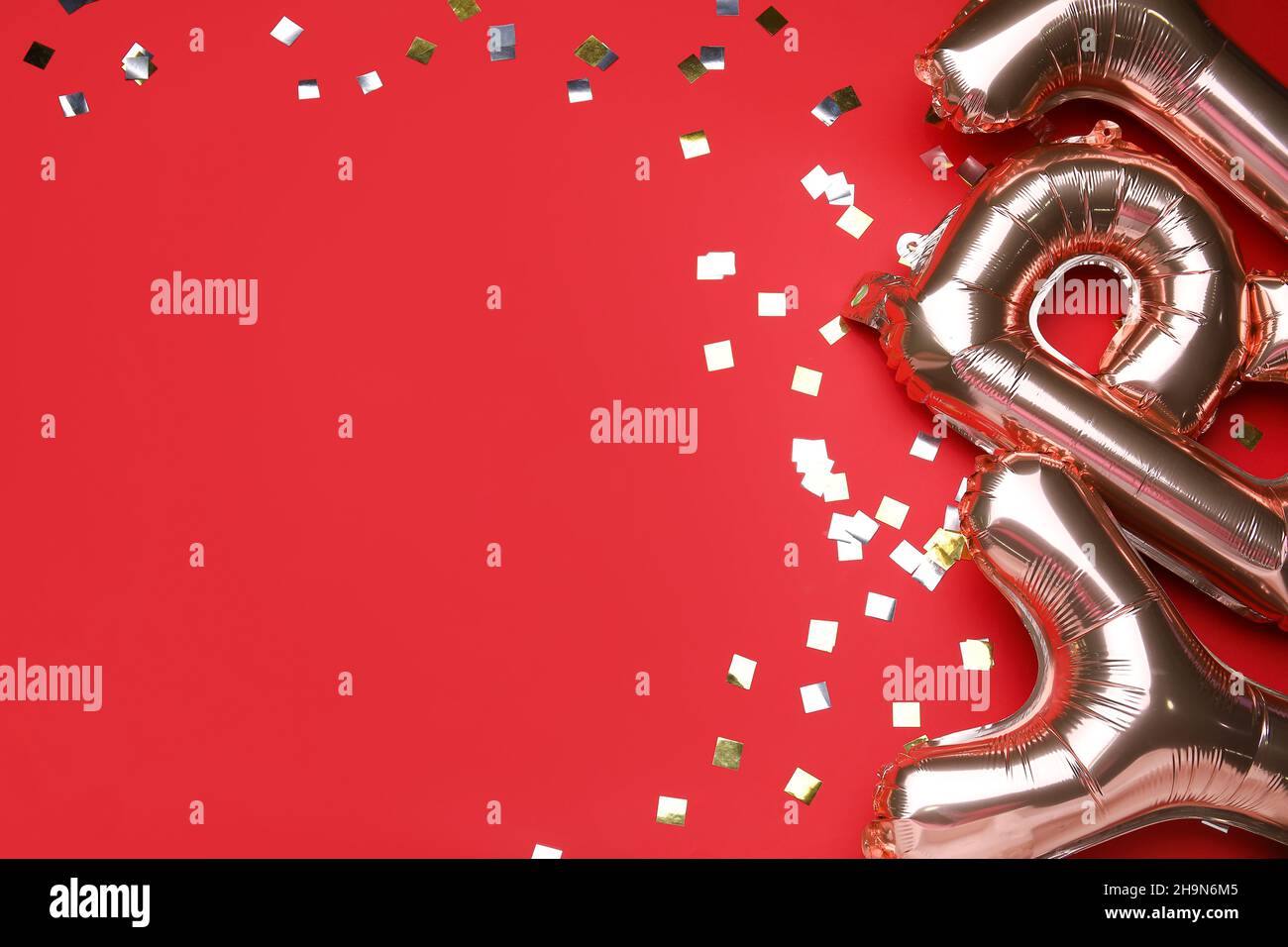 Balloons in shape of letters on red background Stock Photo - Alamy