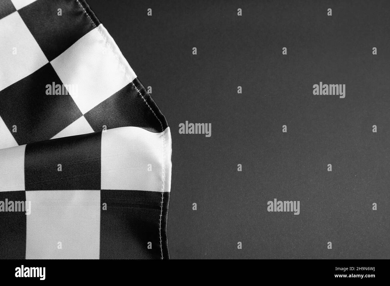 Racing flag on black background Stock Photo - Alamy