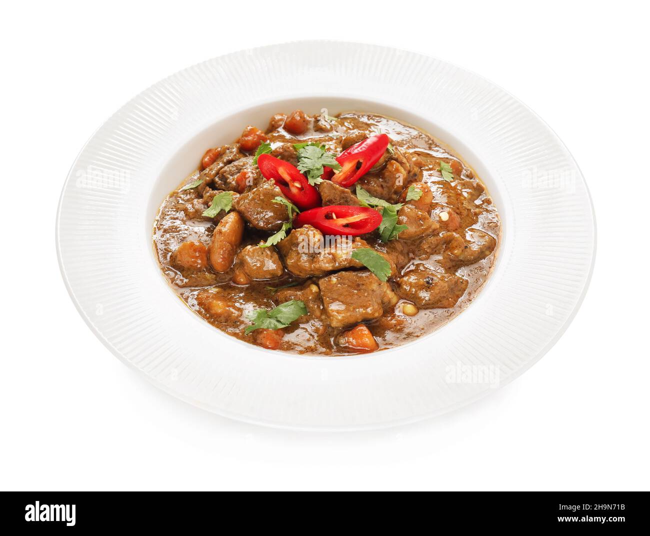 Plate with tasty beef curry on white background Stock Photo - Alamy