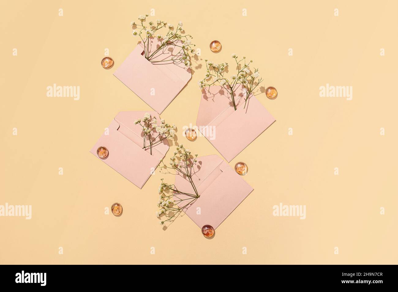 Composition with envelopes and beautiful gypsophila flowers on color ...