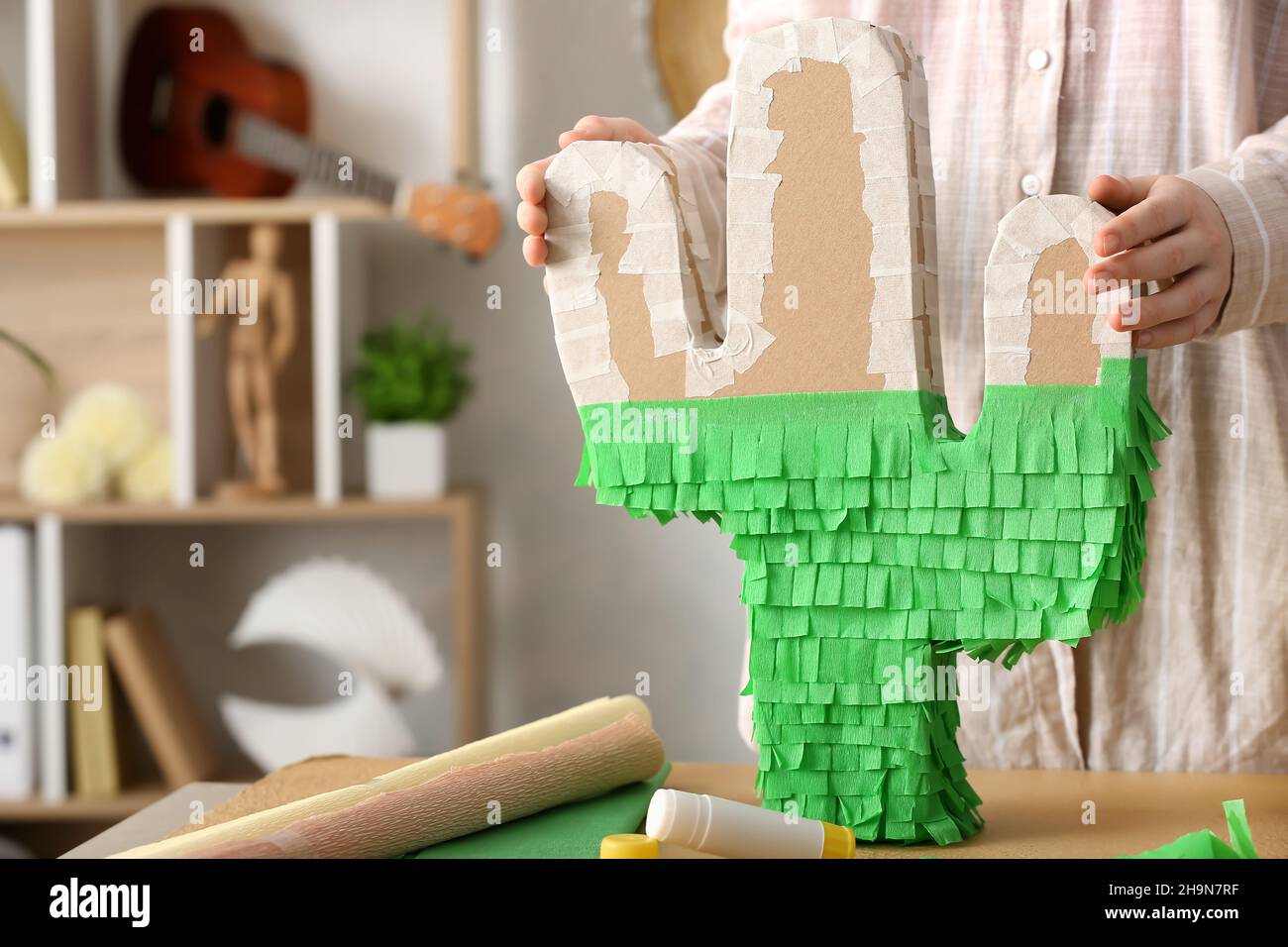 Woman making traditional Mexican pinata at table Stock Photo - Alamy