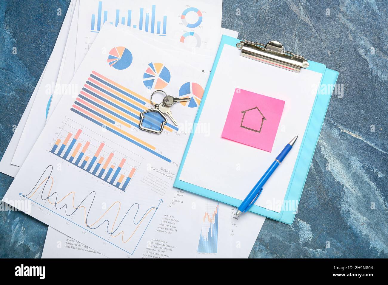 Sticky note with drawn house, clipboard, key and diagrams on grunge ...