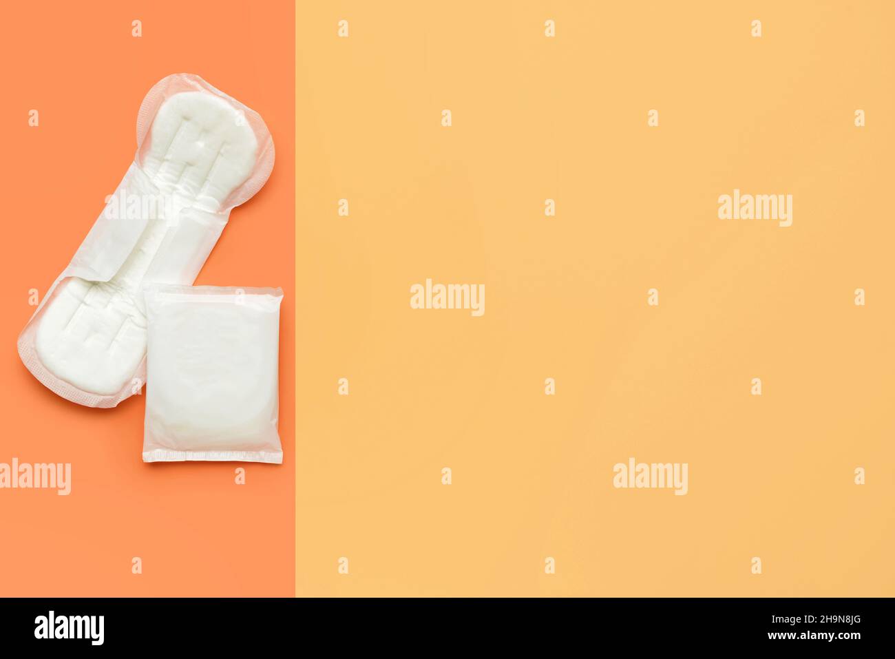 Menstrual pads on orange background Stock Photo - Alamy