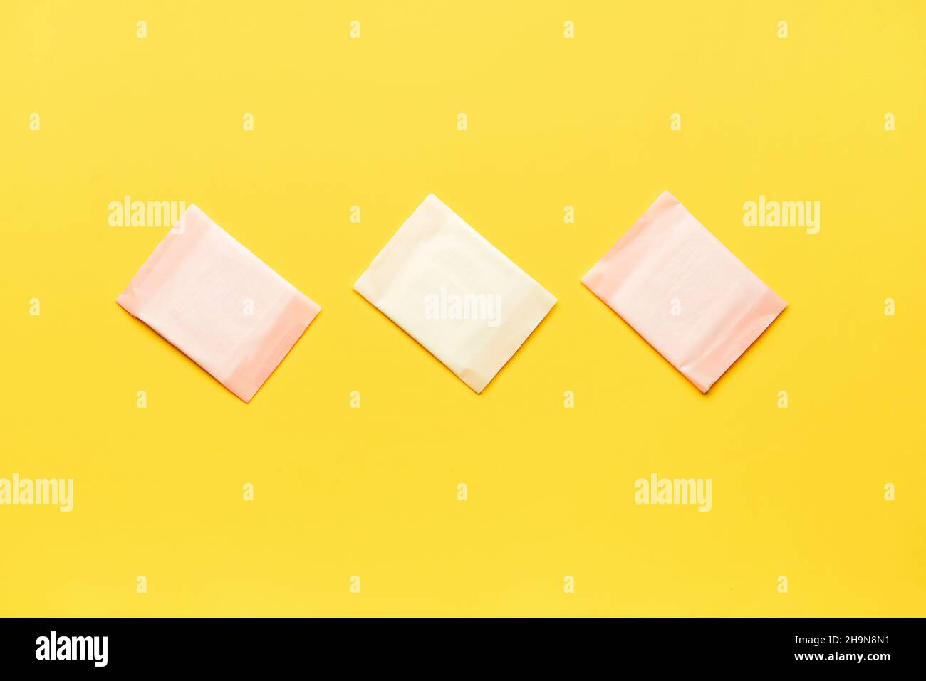 Menstrual pads on yellow background Stock Photo - Alamy