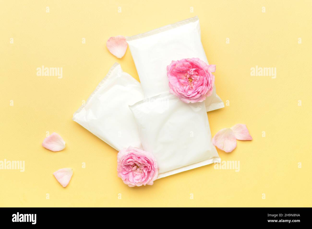 Menstrual pads and flowers on yellow background Stock Photo - Alamy