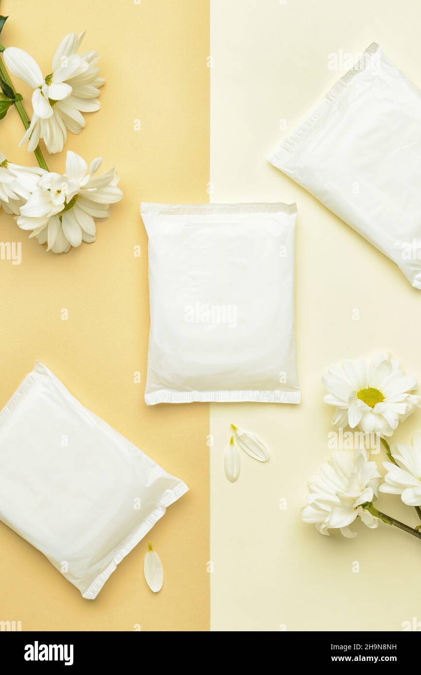 Menstrual pads and flowers on yellow background Stock Photo - Alamy