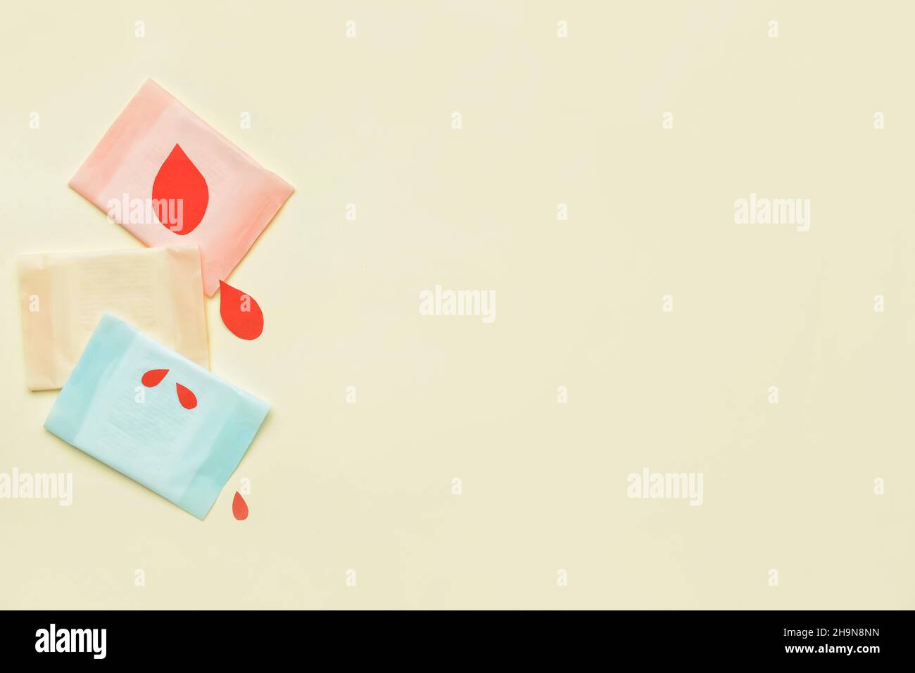 Menstrual pads and paper blood drops on light background Stock Photo ...