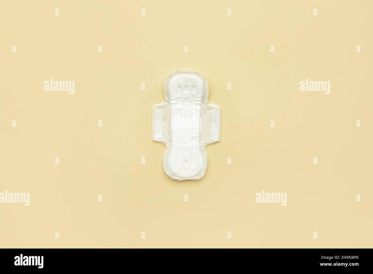 Menstrual pad on yellow background Stock Photo - Alamy