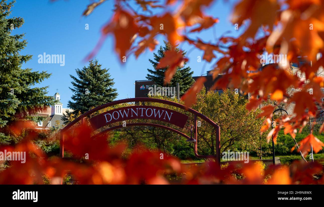 Metallic arch sign with "DOWNTOWN" written on it in the park Stock ...