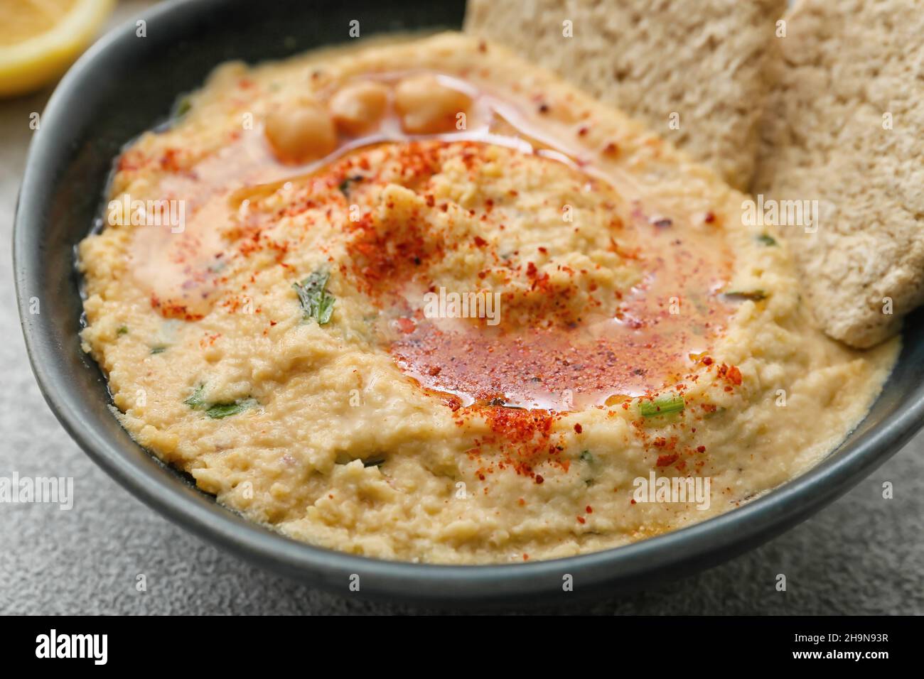 Bowl with delicious hummus on table, closeup Stock Photo - Alamy