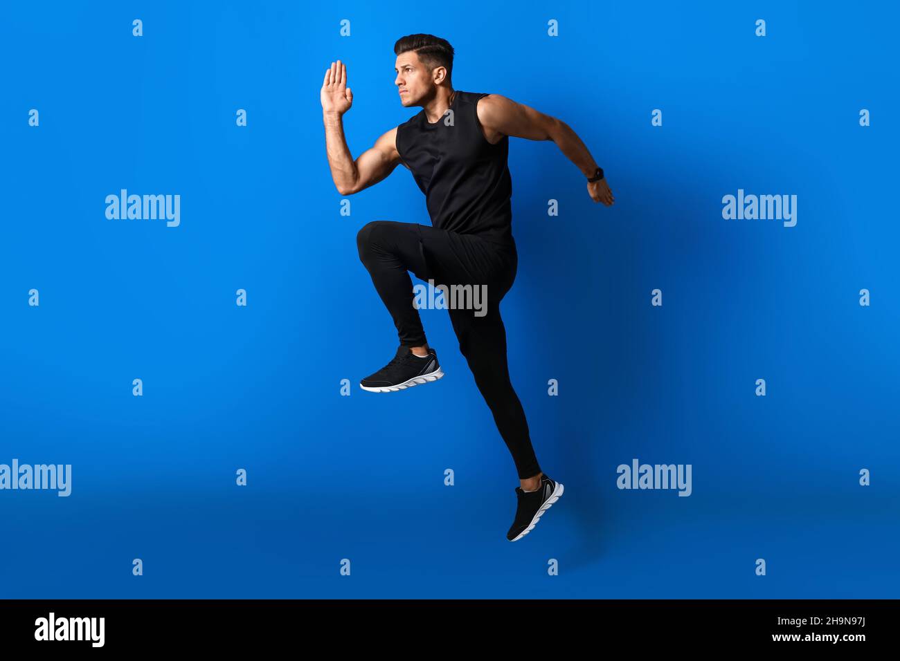 Sporty male runner on color background Stock Photo - Alamy